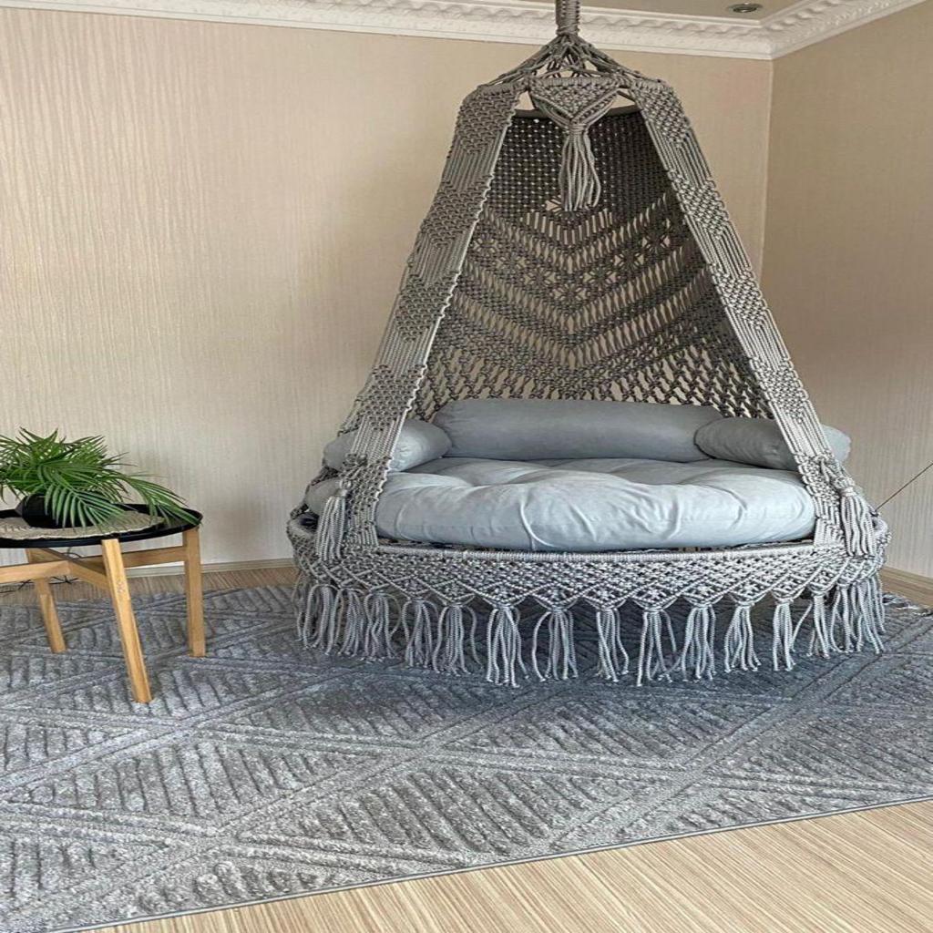 Cozy Macrame Swing for Relaxation and Comfort.